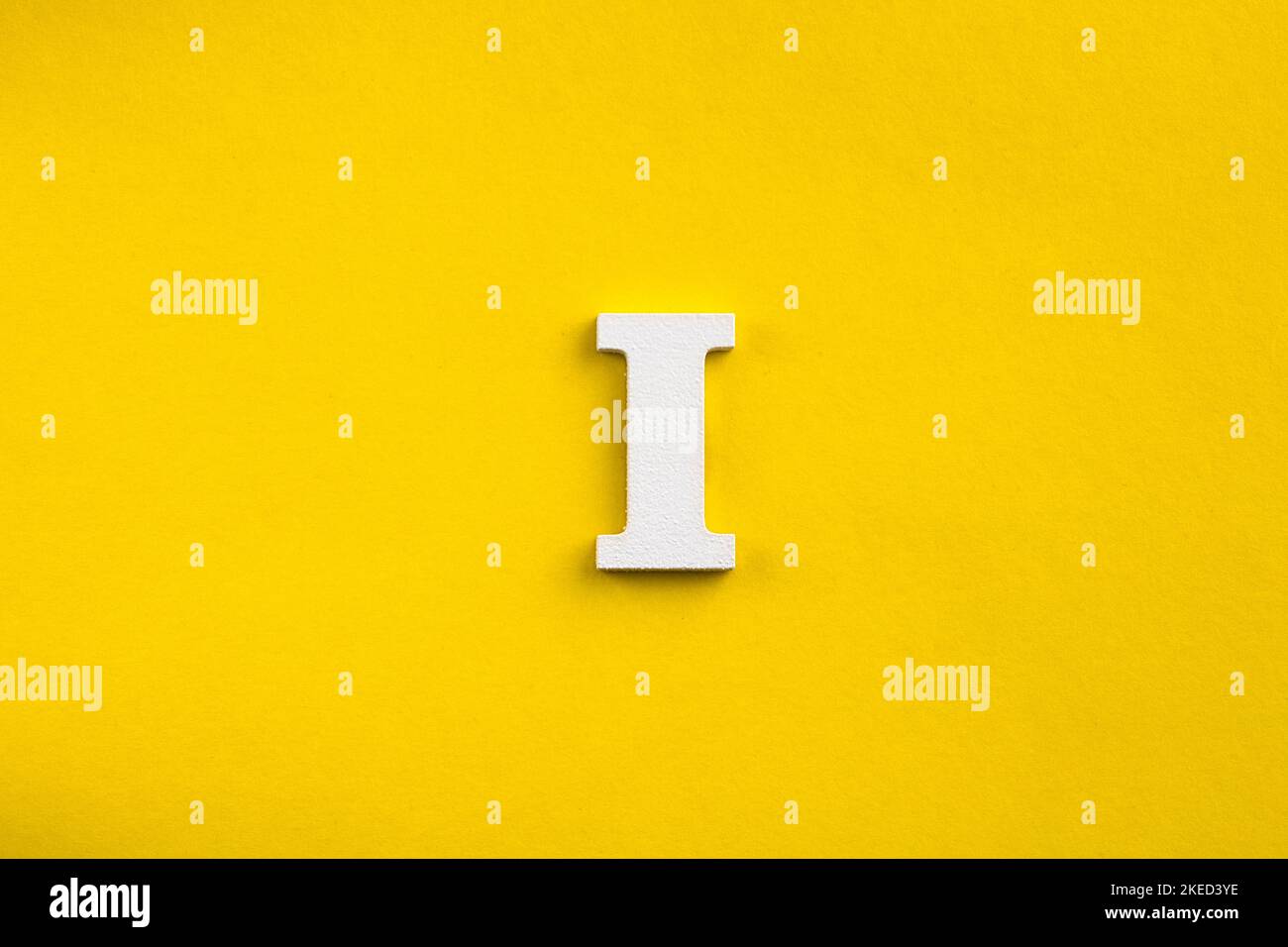 letter I uppercase - white wood letter on yellow color background Stock ...