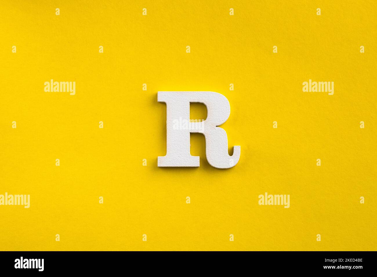 letter R uppercase - white wood letter on yellow color background Stock ...