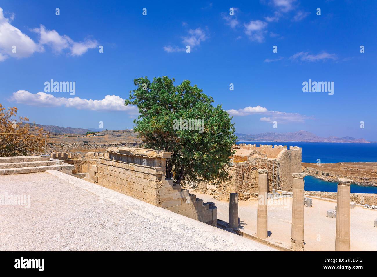Panoramic view of ruins of ancient city of Lindos on colorful island of ...