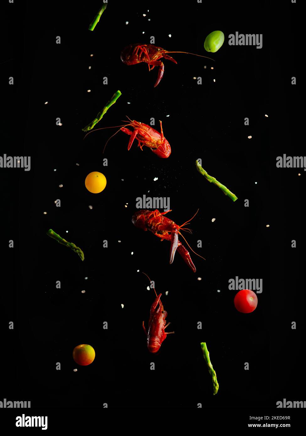 Boiled crayfish, pieces of asparagus, red and yellow cherry tomatoes in ...