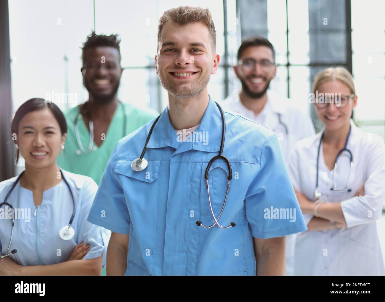 Multinational interns and professor cooperating at a hospital meeting ...