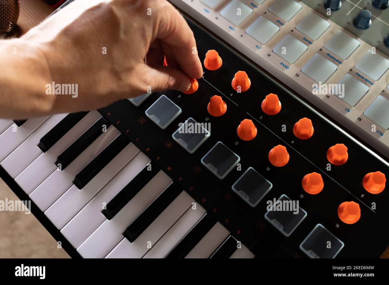 The musician plays the midi keyboard. Close-up. The concept is modern ...