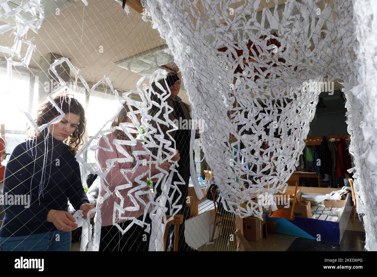 Ukrainians are seen weaving winter camouflage nets for the army. Russia ...