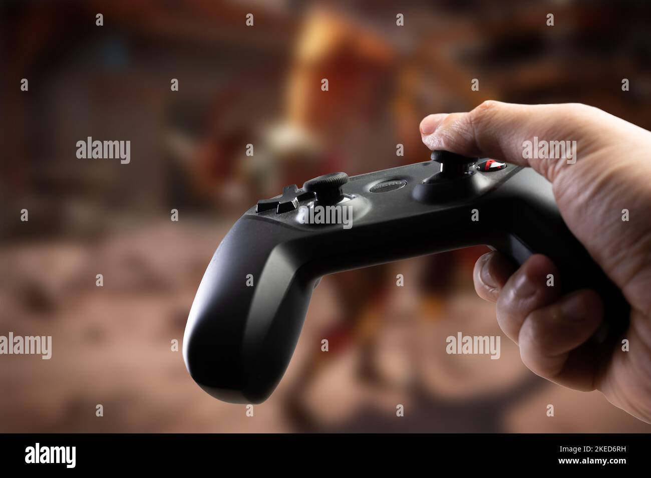 Against the background of an adventure video game on a large screen, a ...