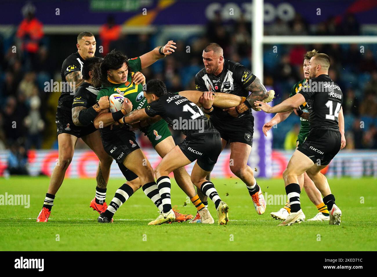Australia's Tino Fa'asuamaleaui is tackled by New Zealand during the ...