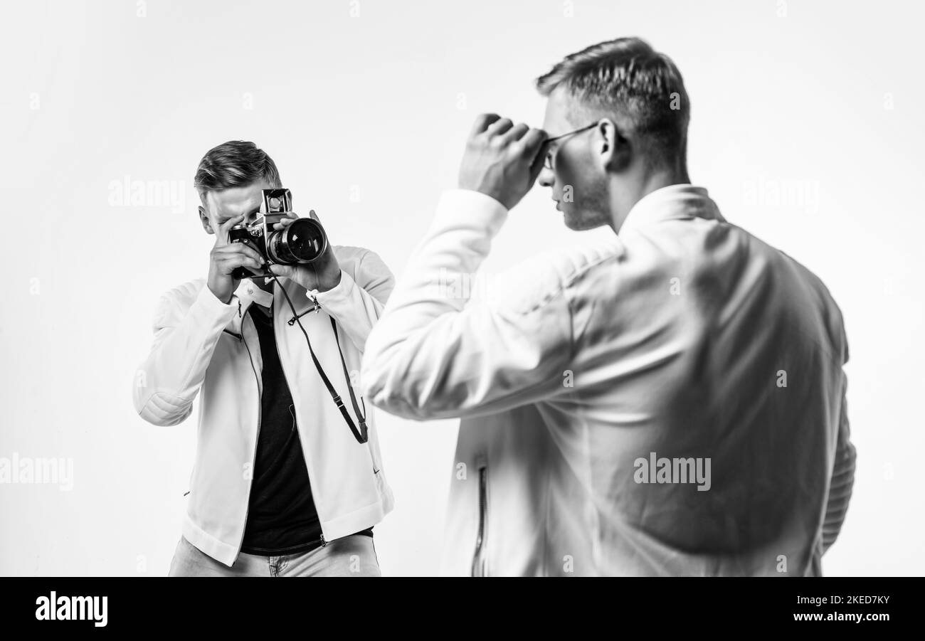 confident model photographer. twins brother in white. photographing ...
