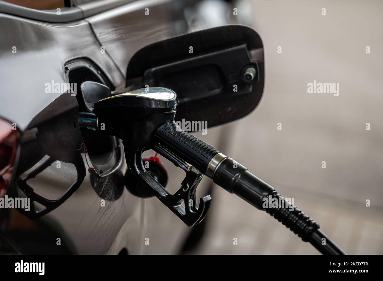 A car at gas station being filled with fuel, close-up, rear view Stock ...