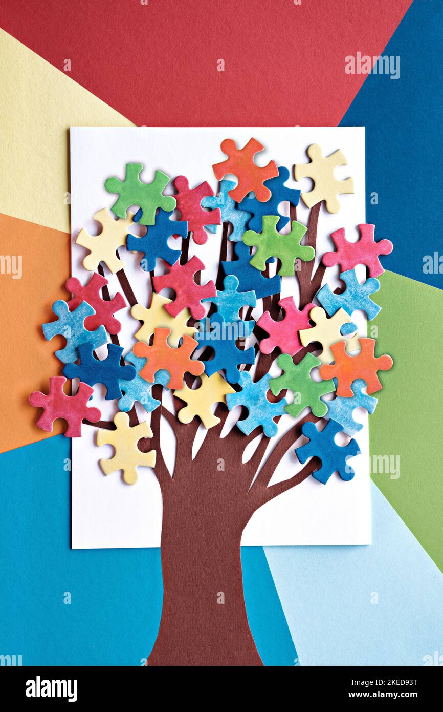 vAbstract tree with colorful vibrant puzzle pieces on off white ...