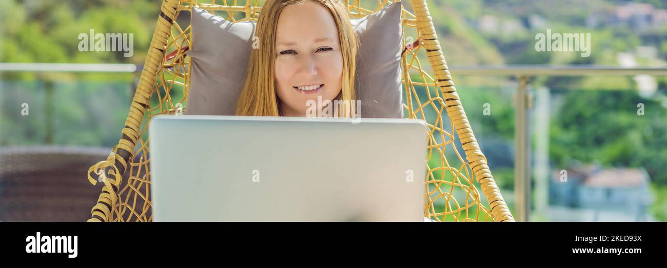 BANNER, LONG FORMAT Caucasian woman sitting on the terrace working from ...