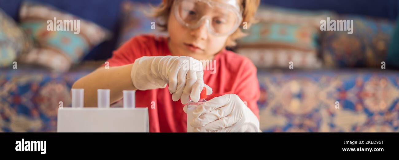 BANNER, LONG FORMAT Kid boy doing chemical experiment at home. Child ...