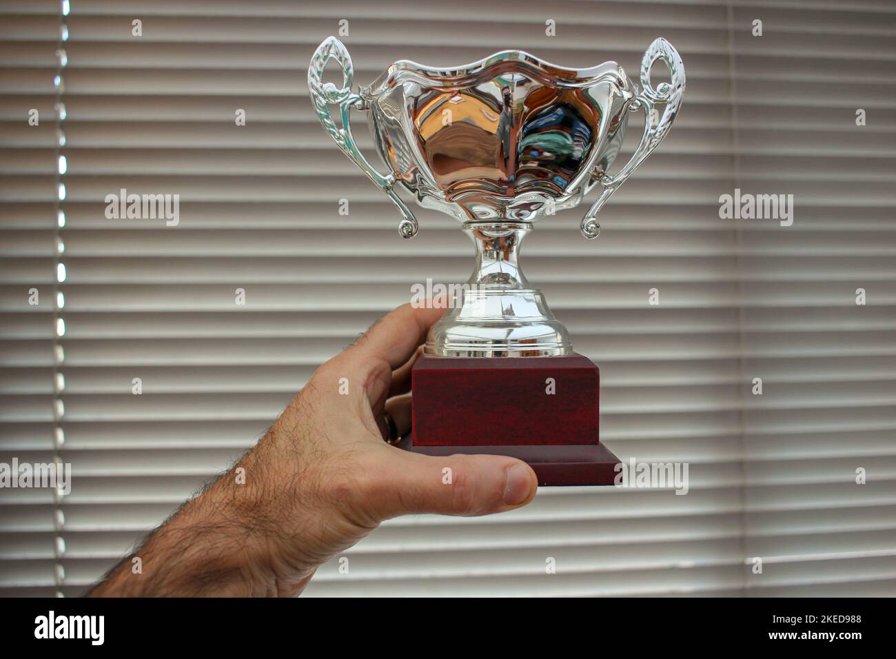 winning a trophy as the best in getting better each day Stock Photo - Alamy