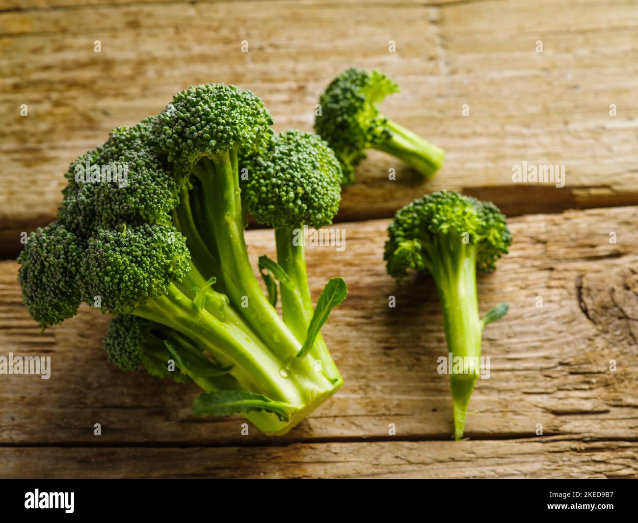 Green broccoli on a simple wooden table. Close-up. Minimalism. Organic ...