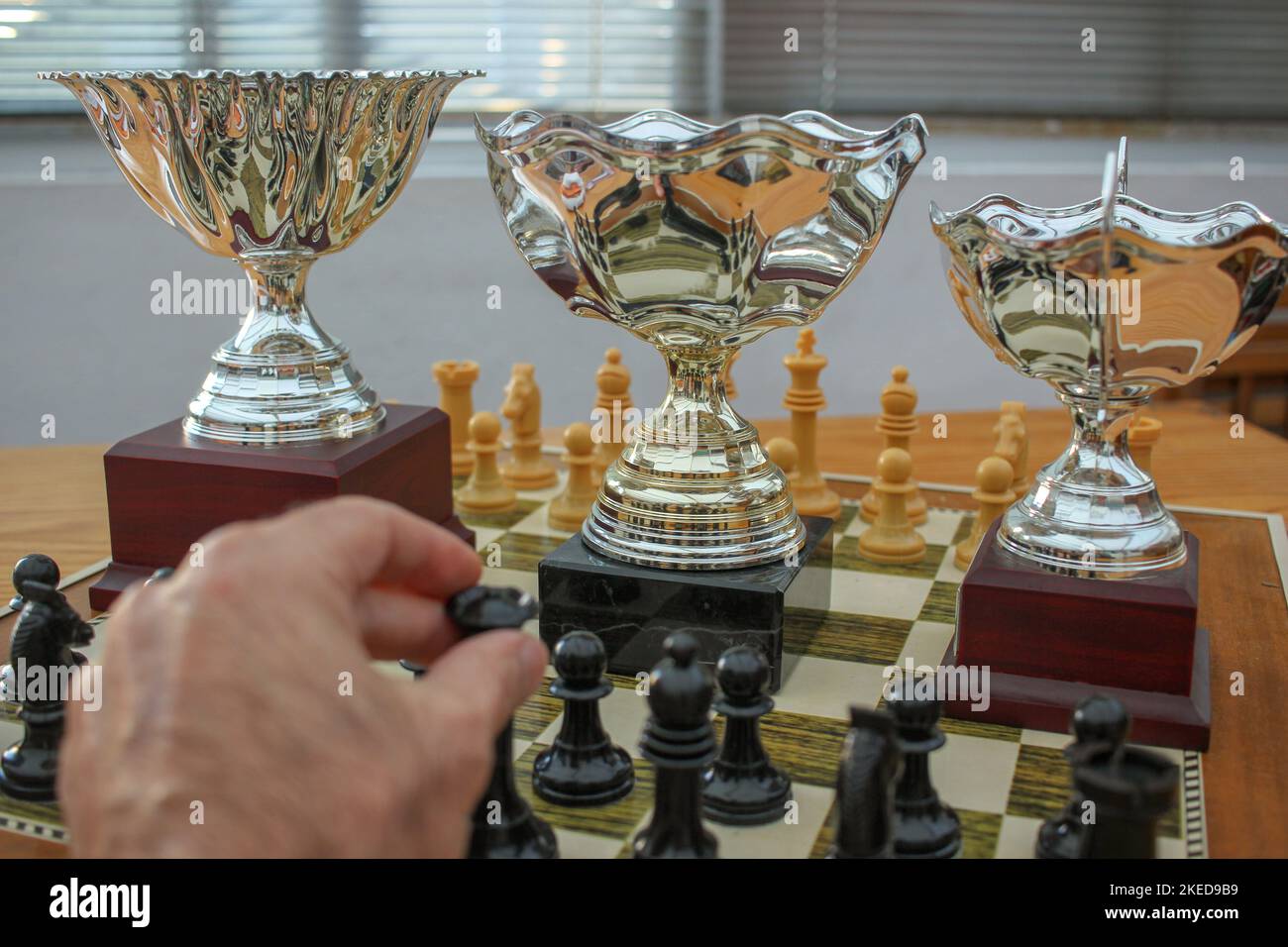 a human hand moving the chess pieces to achieve the best results Stock ...
