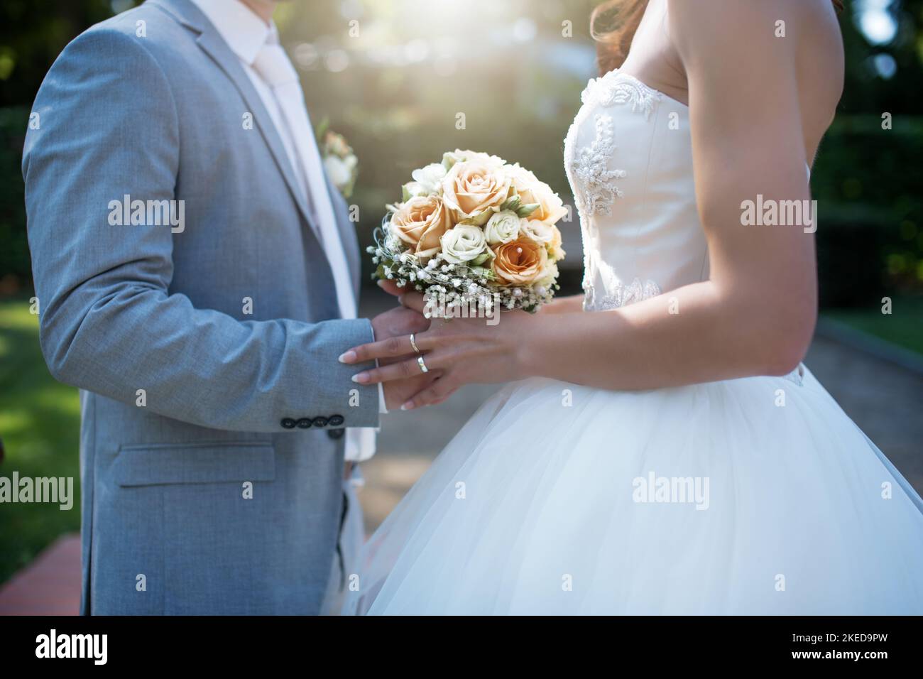a closeup of newlyweds holding hands at their wedding ceremony Stock ...