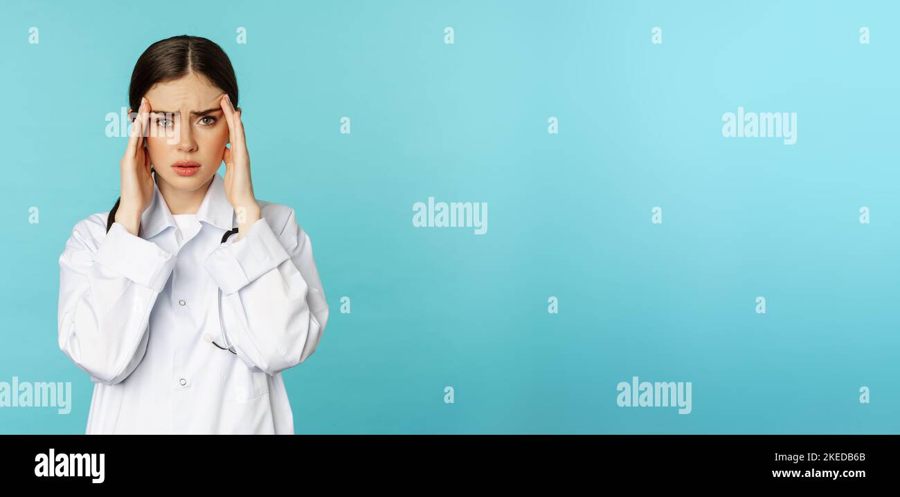 Image of woman doctor, medical personel grimacing from discomfort ...