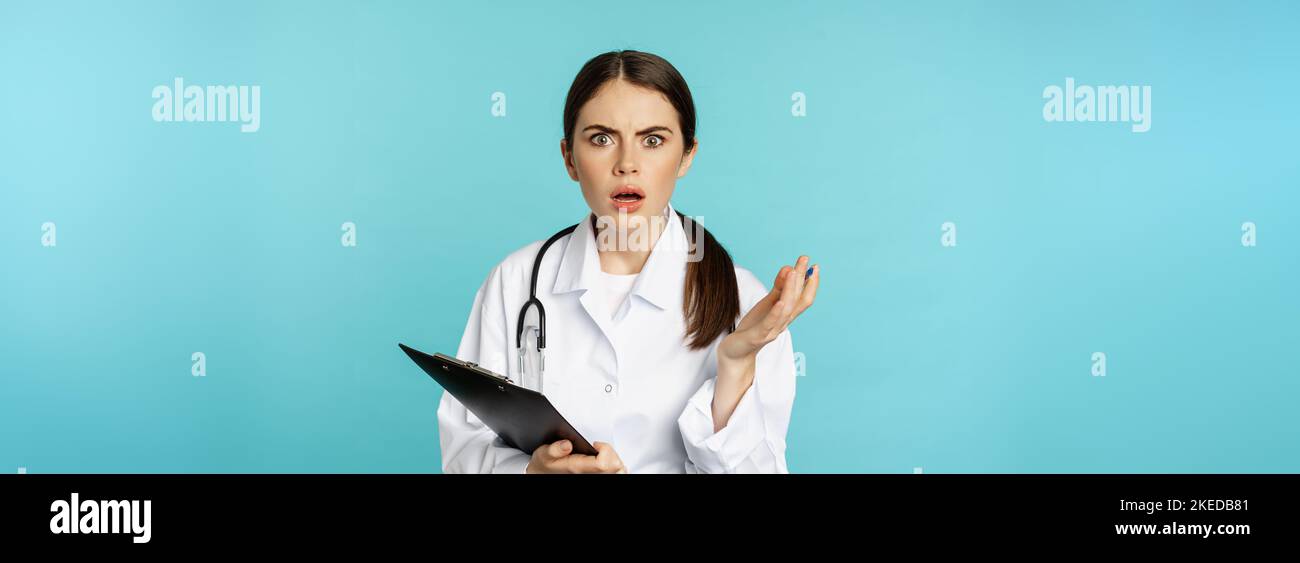 Shocked woman doctor reacting worried and frustrated at camera, hear ...