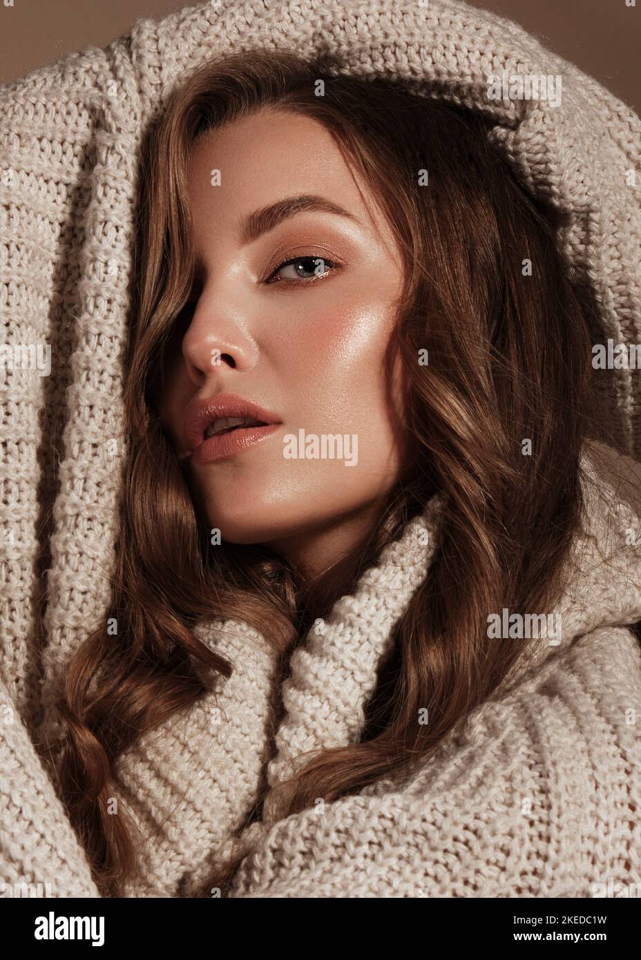 Beautiful young girl with gentle make-up in warm sweater and long ...