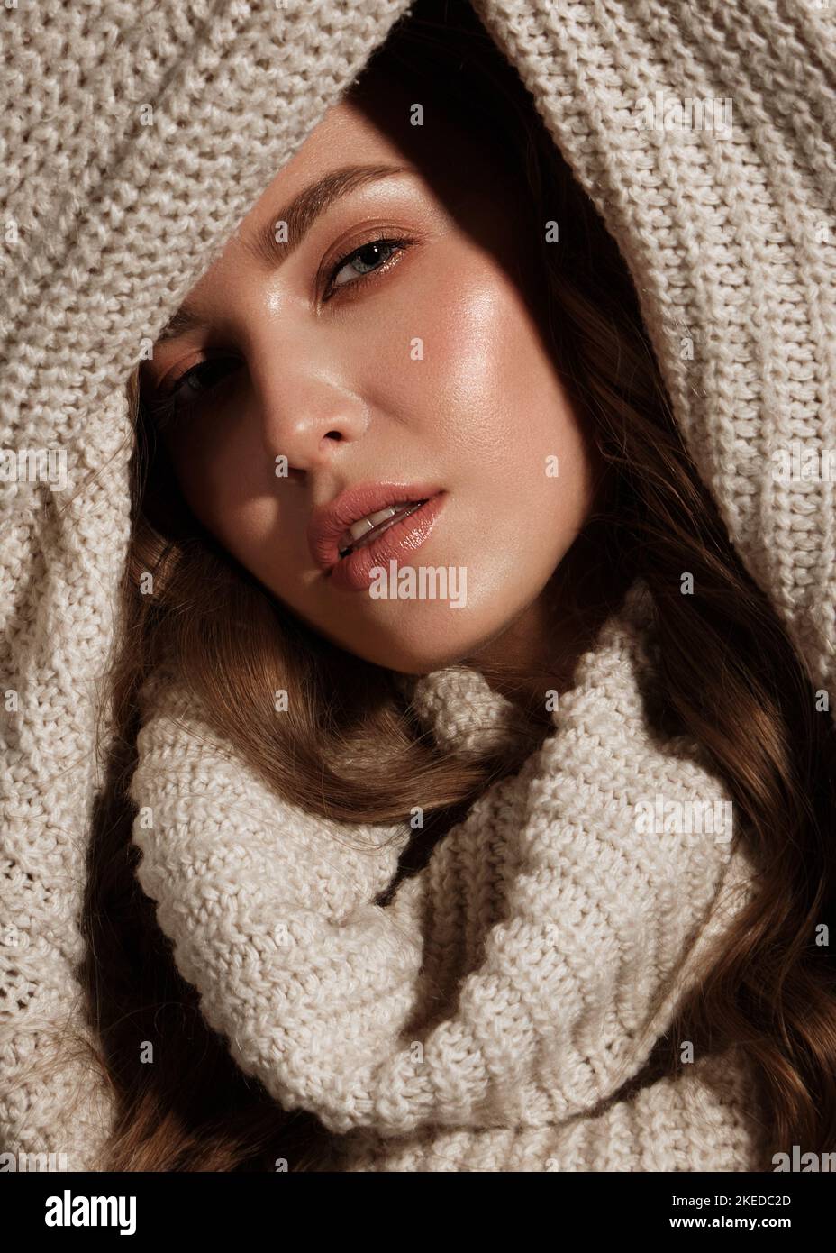 Beautiful young girl with gentle make-up in warm sweater and long ...