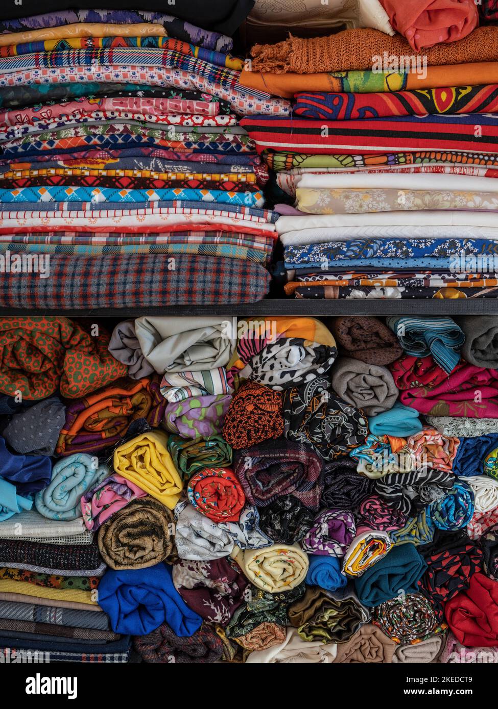 Folded and rolled fabrics on wooden shelves in drapery Stock Photo - Alamy