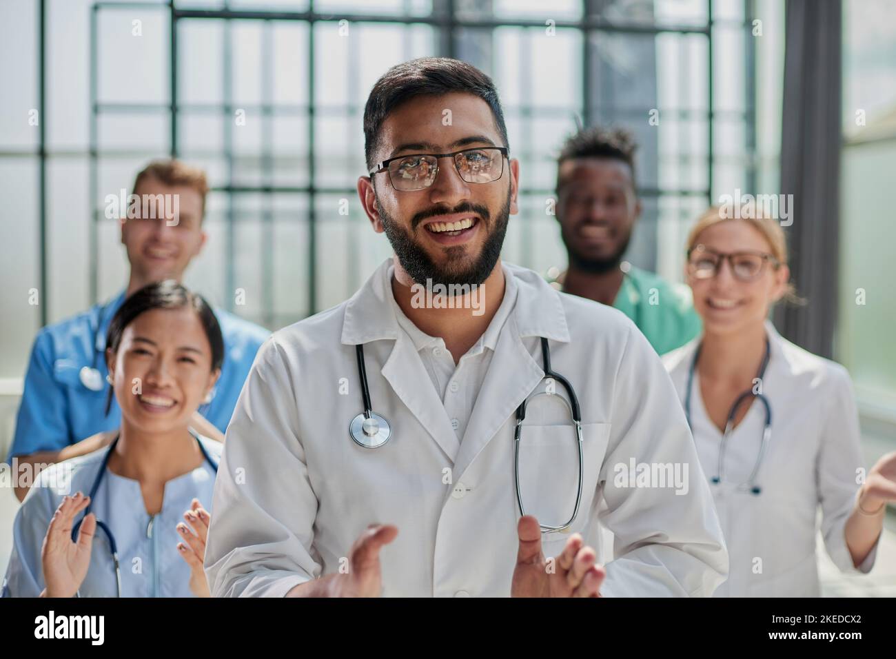 Successful team of medical doctors are looking at camera and smiling ...