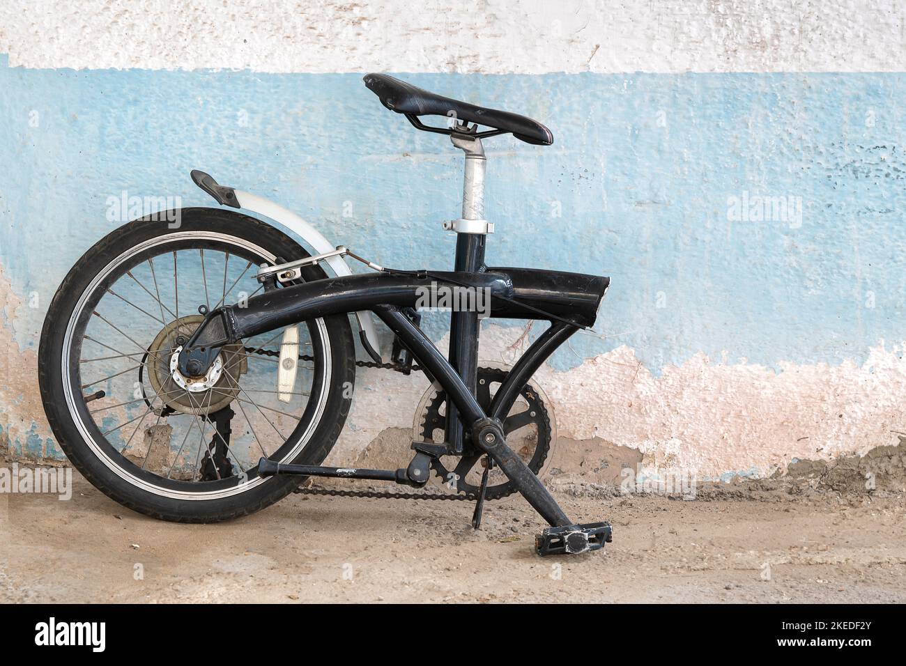 Back half of a bicycle broken into two parts against the wall Stock ...