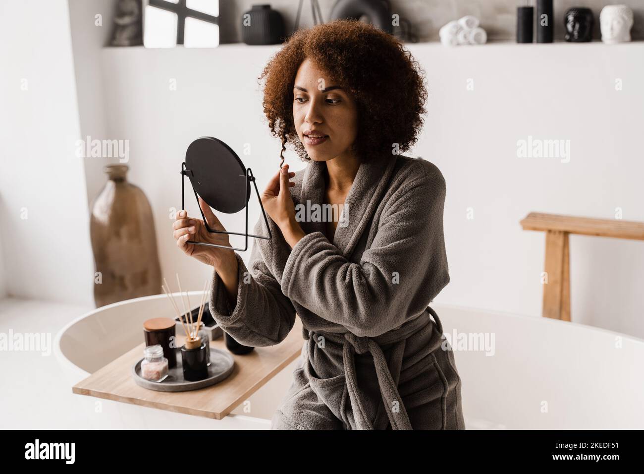 African american cheerful woman doing beauty spa procedures and take ...