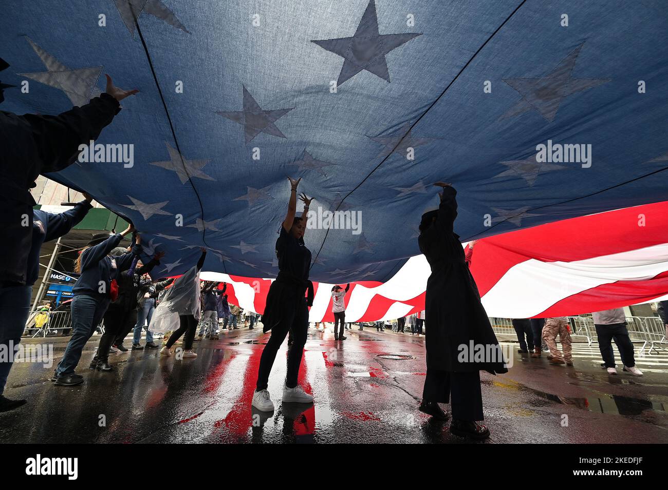 Military veterans hold an American flag as they march up Fifth Avenue during the annual New York ...
