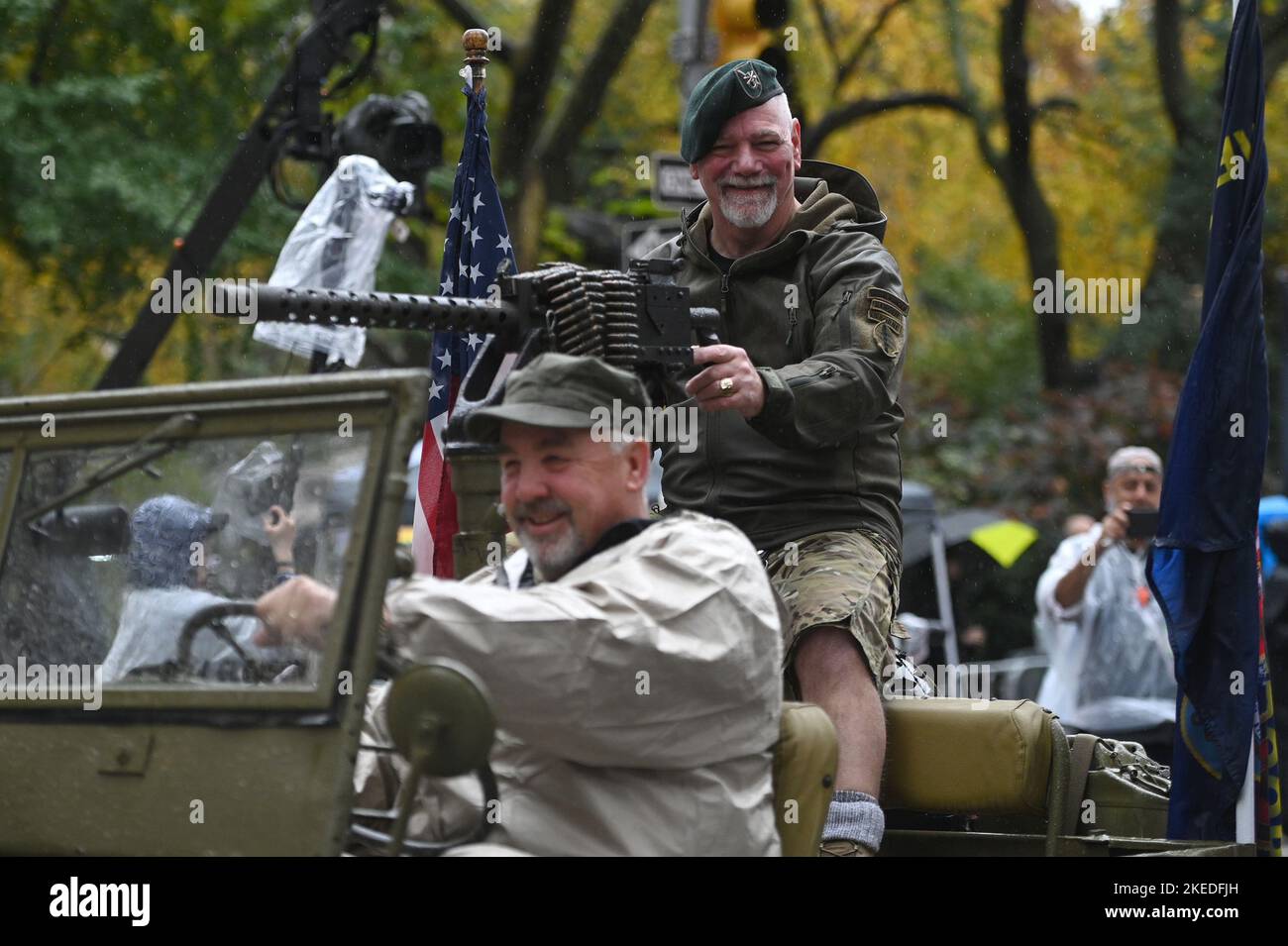 A military veteran riding in a machine gun-mounted jeep makes his way up Fifth Avenue during the ...