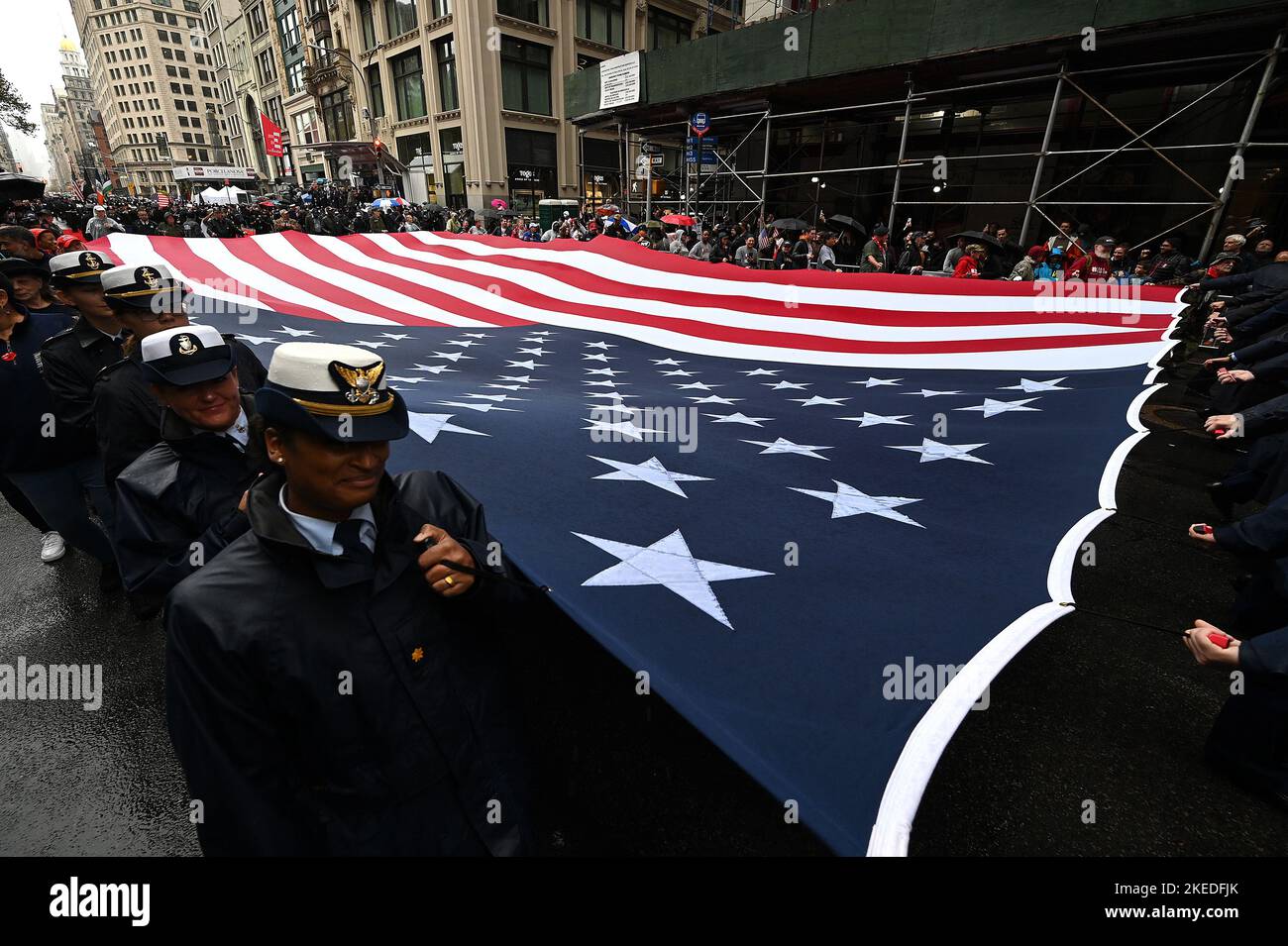 Military veterans hold an American flag as they march up Fifth Avenue during the annual New York ...