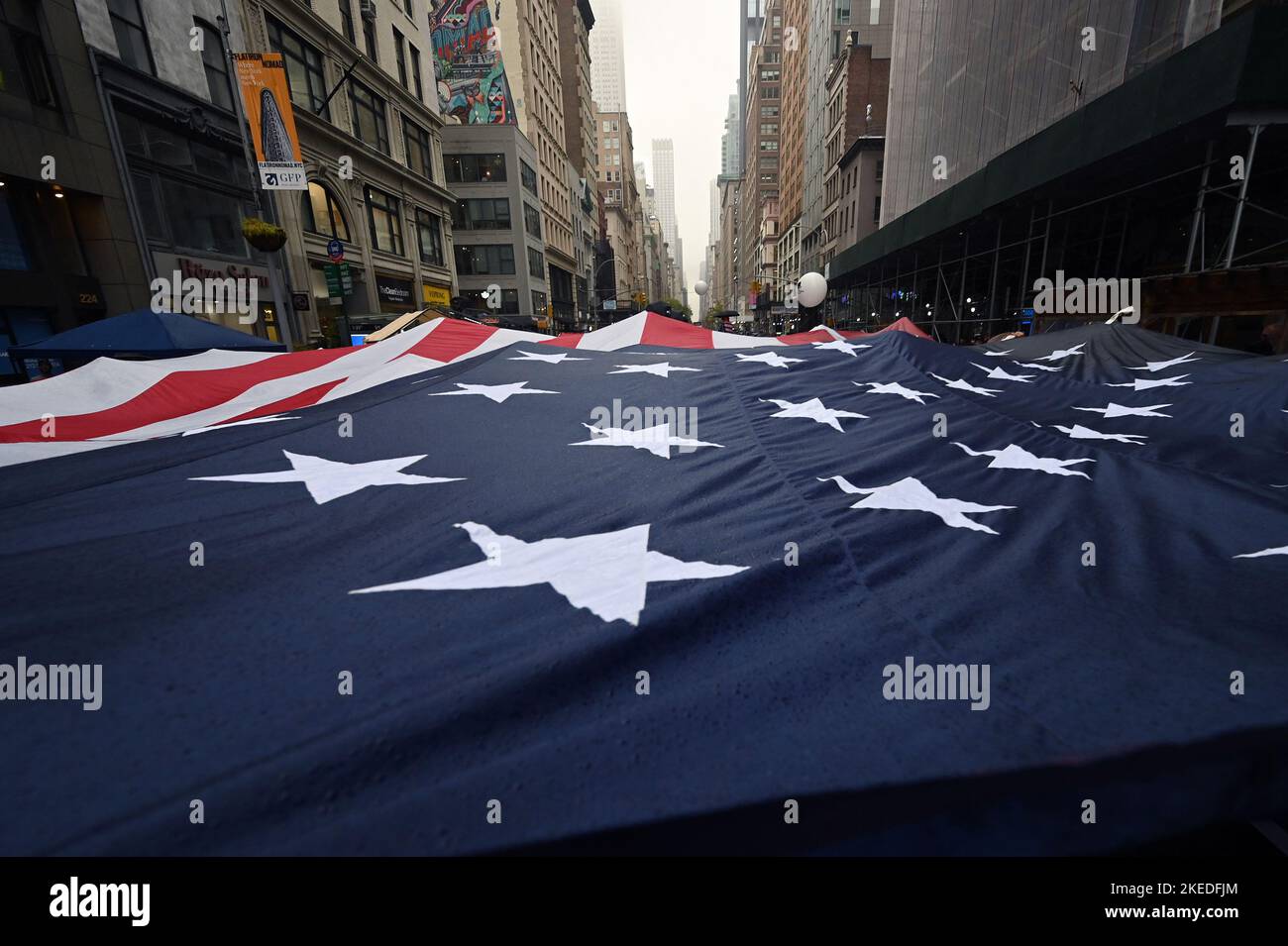 Military veterans hold an American flag as they march up Fifth Avenue during the annual New York ...