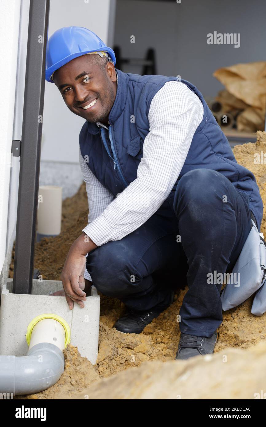 happy tradesman working with pipes Stock Photo - Alamy
