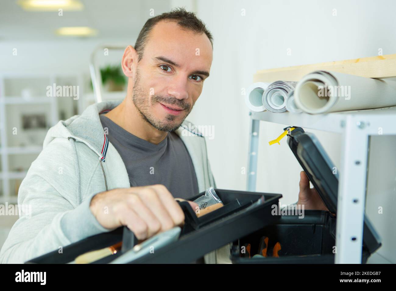 man doing diy taking tool out of toobox Stock Photo - Alamy