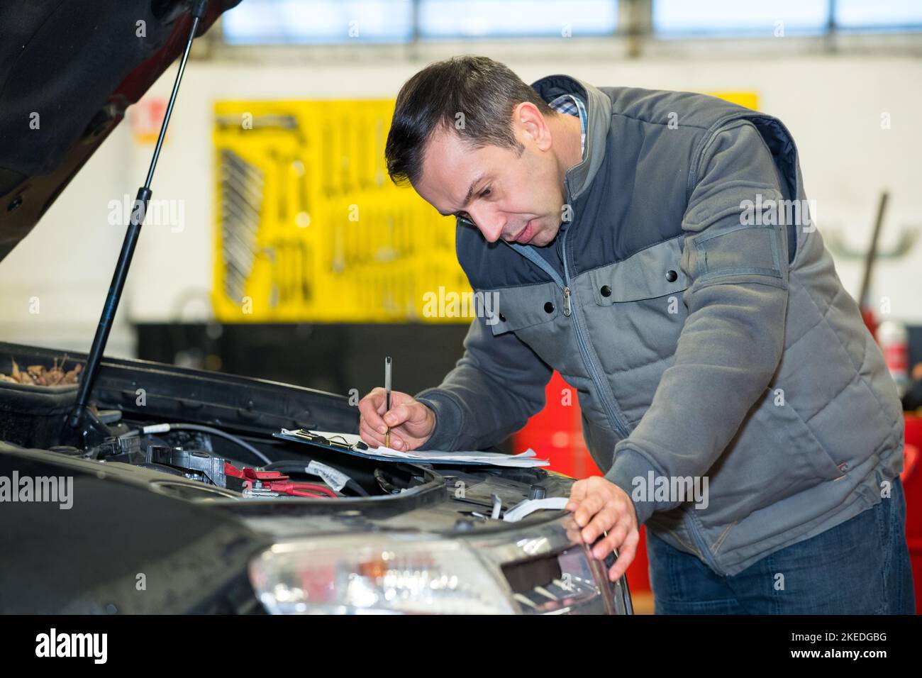mechanic doing an engine check-up Stock Photo - Alamy