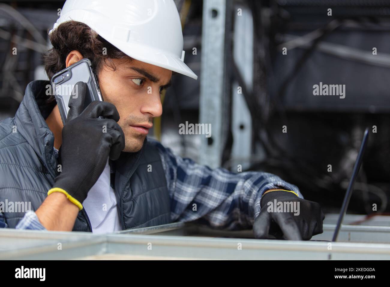 builder on cell phone in the ceiling Stock Photo - Alamy