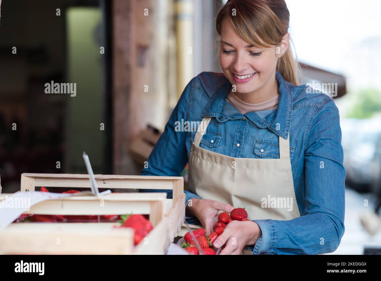 a person picking a box of strawberries Stock Photo - Alamy