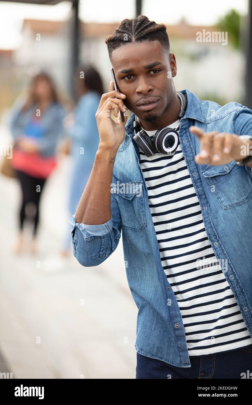 man with headphone calling phone in the street Stock Photo - Alamy