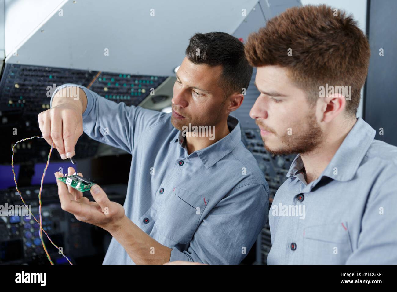 two technicians repairing a machine Stock Photo - Alamy