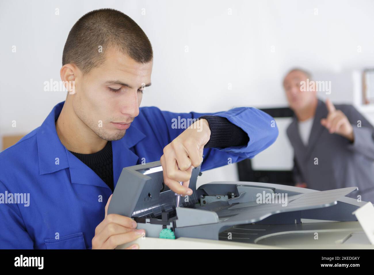 a man fixing a printer Stock Photo - Alamy