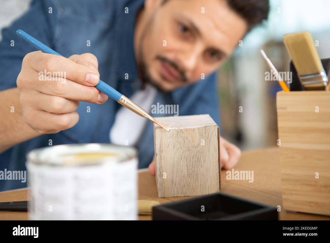 man is painting a ceramic Stock Photo - Alamy