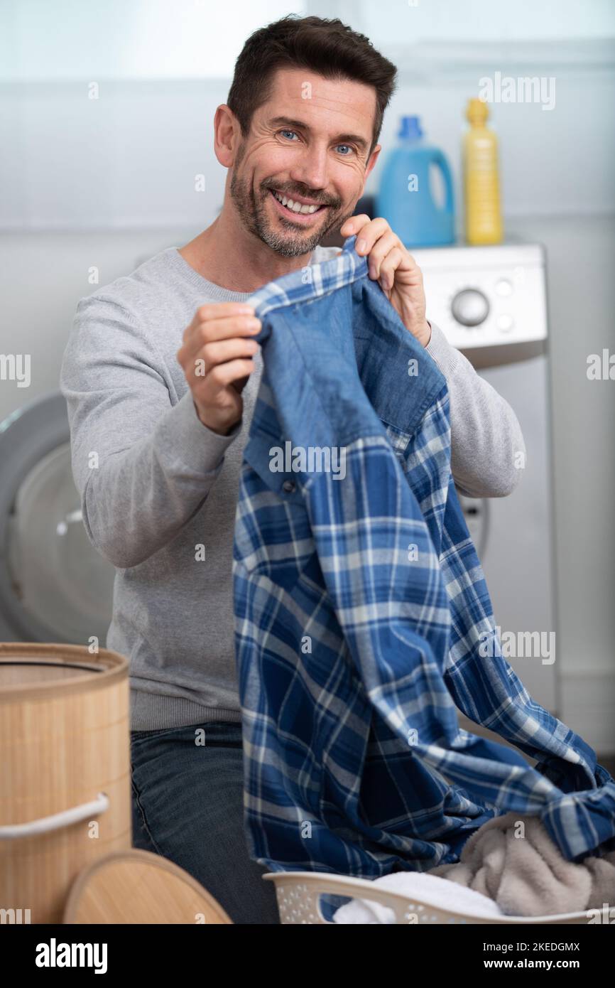 handsome businessman doing his weekly washing in a laundromat Stock ...