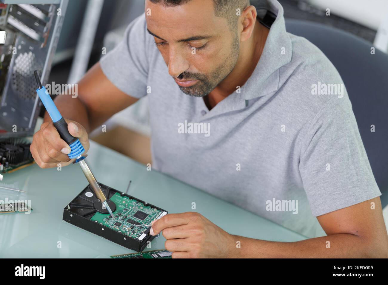 male technician soldering computer component Stock Photo - Alamy