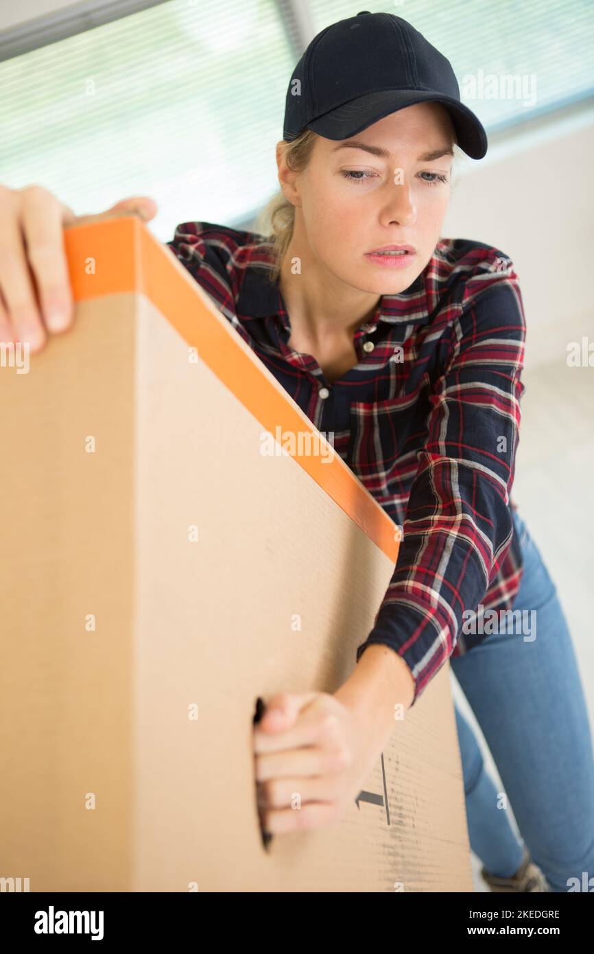 female warehouse worker carrying box Stock Photo - Alamy