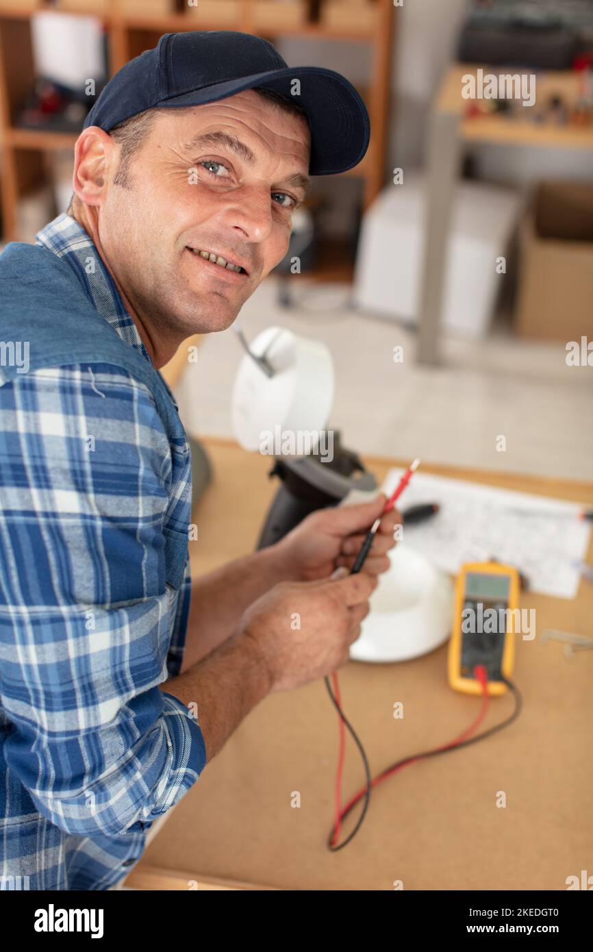 electrician using multimeter in renovation property Stock Photo - Alamy