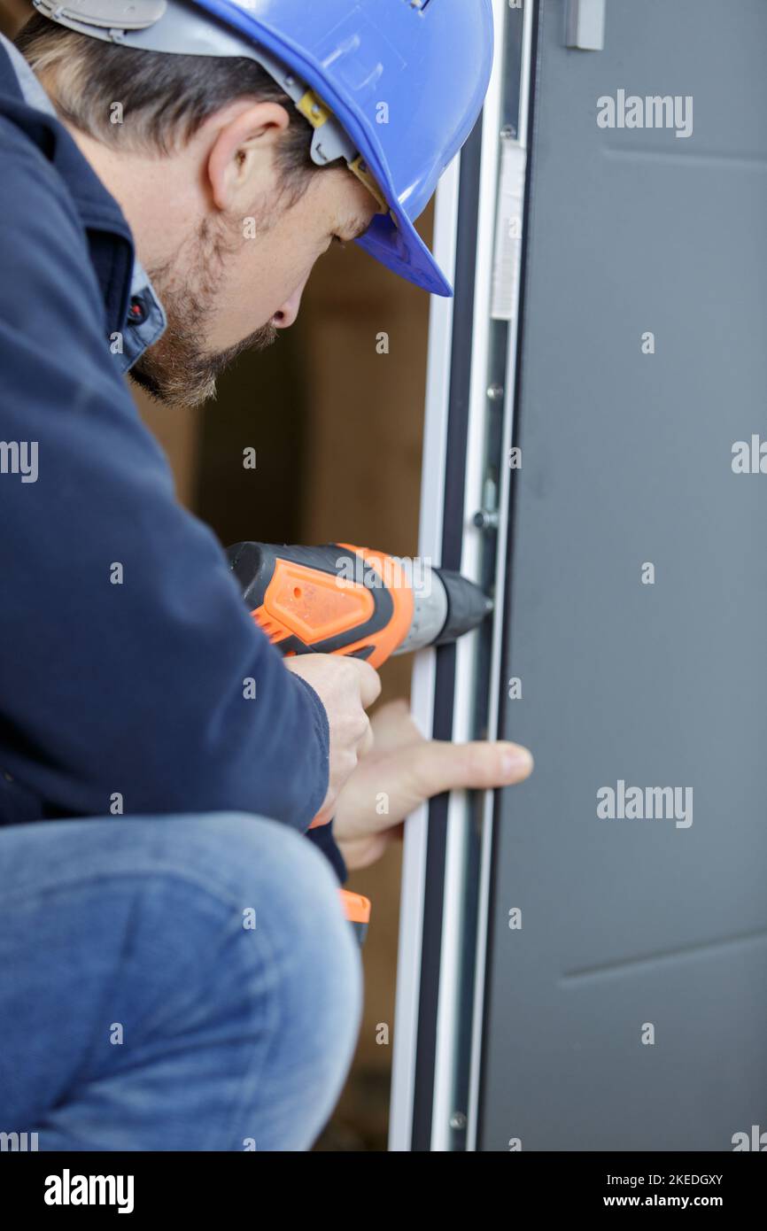 worker installing doors on the closet Stock Photo - Alamy