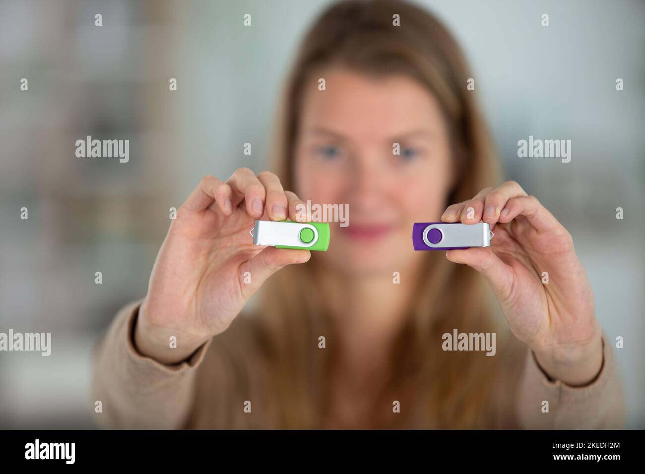 a woman holding 2 usb keys Stock Photo - Alamy