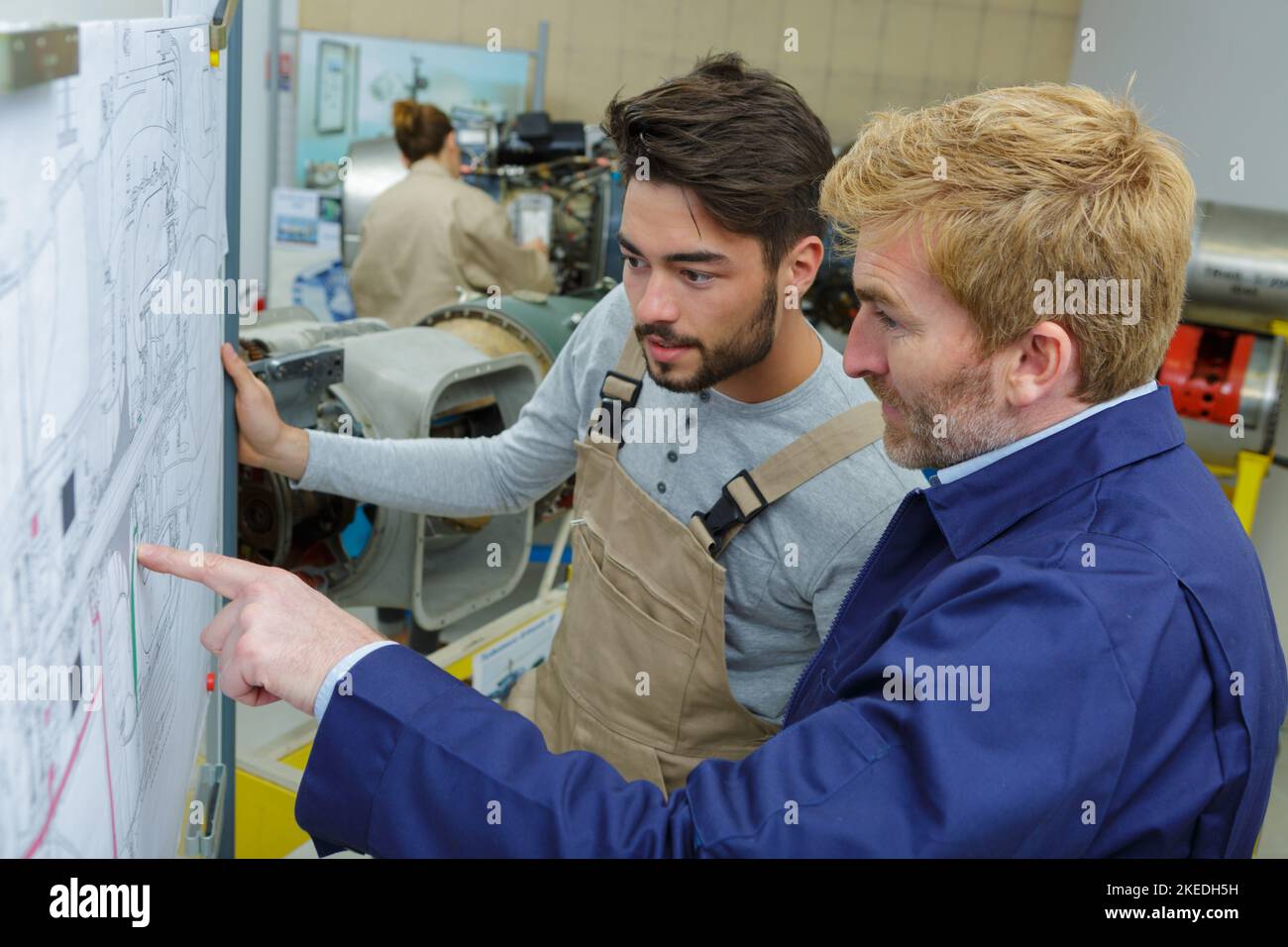 two male engineers working with new project on drawing board Stock ...