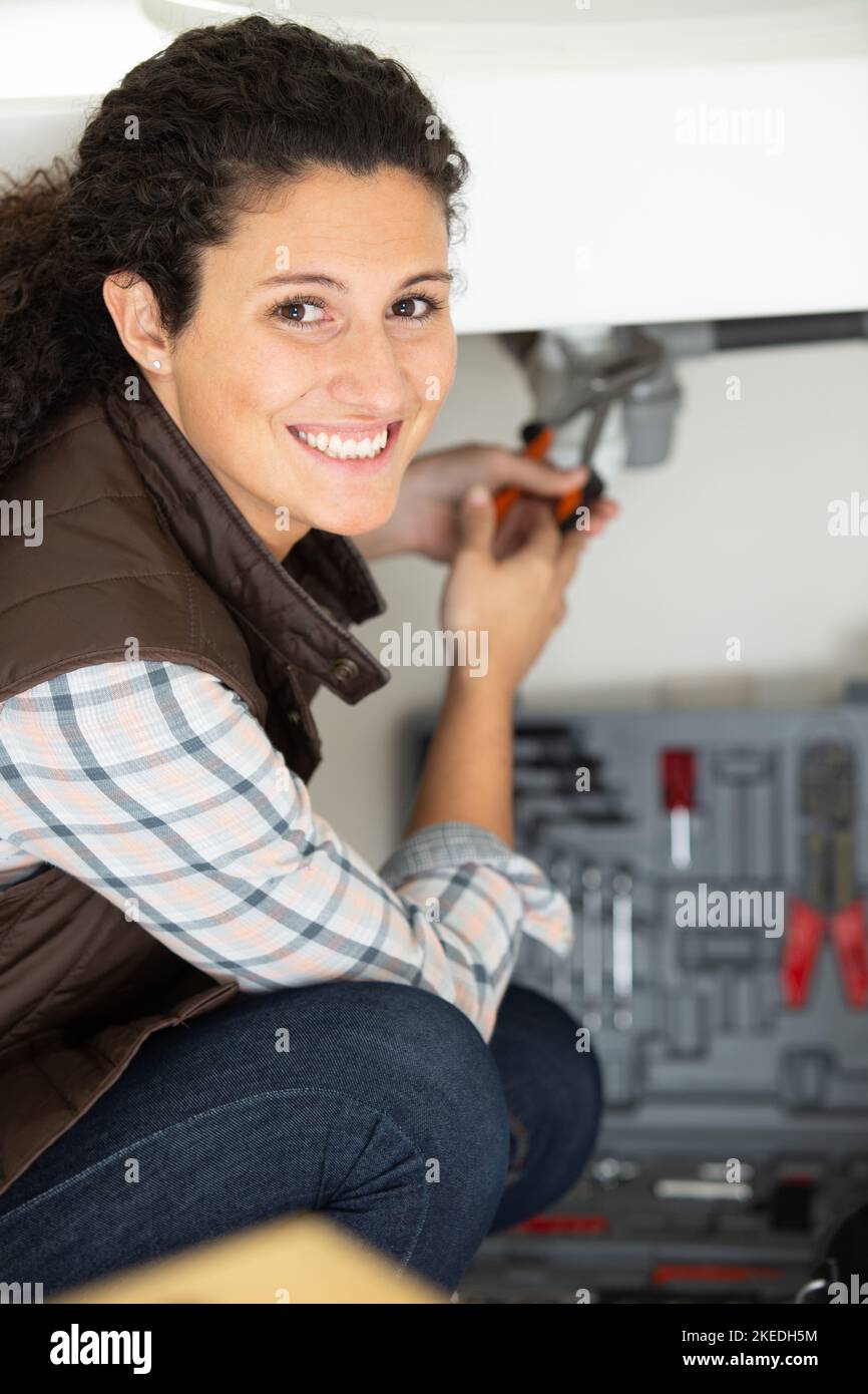 happy plumber woman installing pipes Stock Photo - Alamy