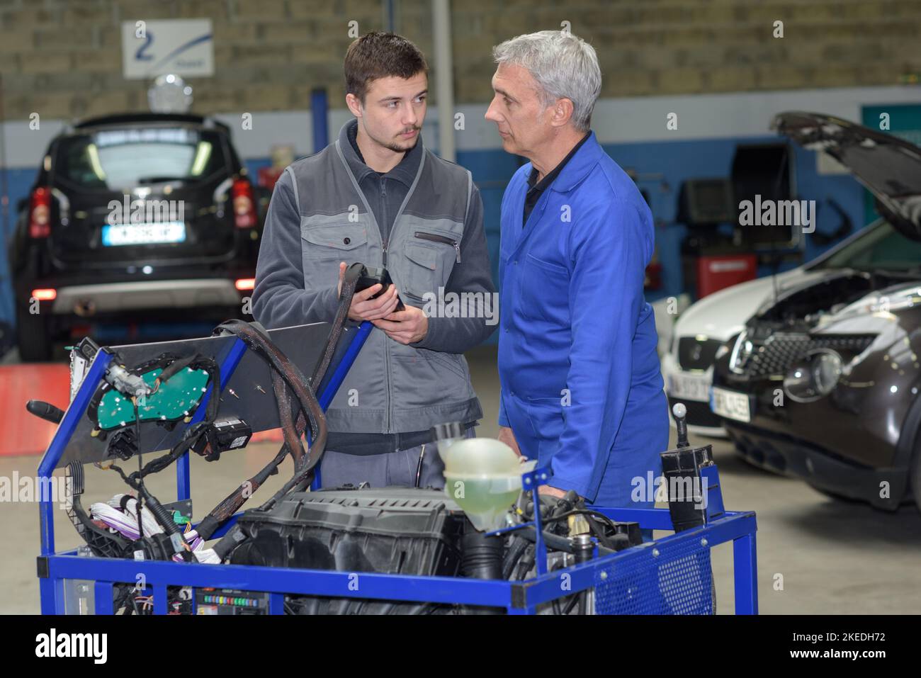 student with instructor repairing a car during apprenticeship Stock ...