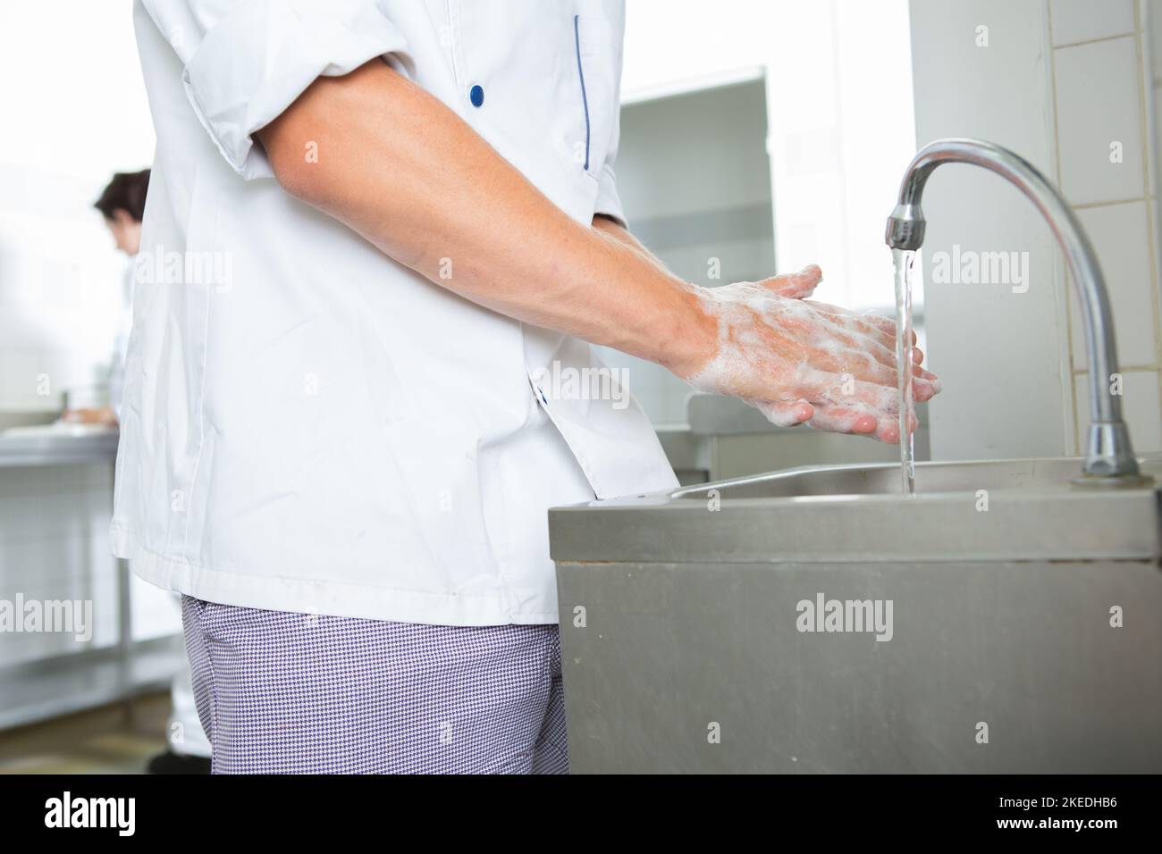 mid section of chef washing his hands Stock Photo - Alamy