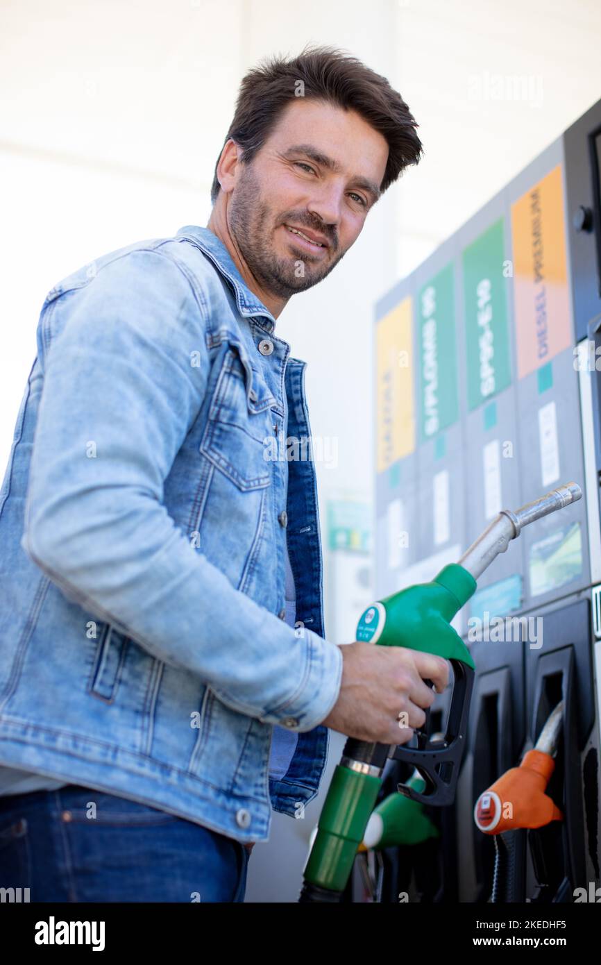 man pumping gasoline fuel in car at gas station Stock Photo - Alamy